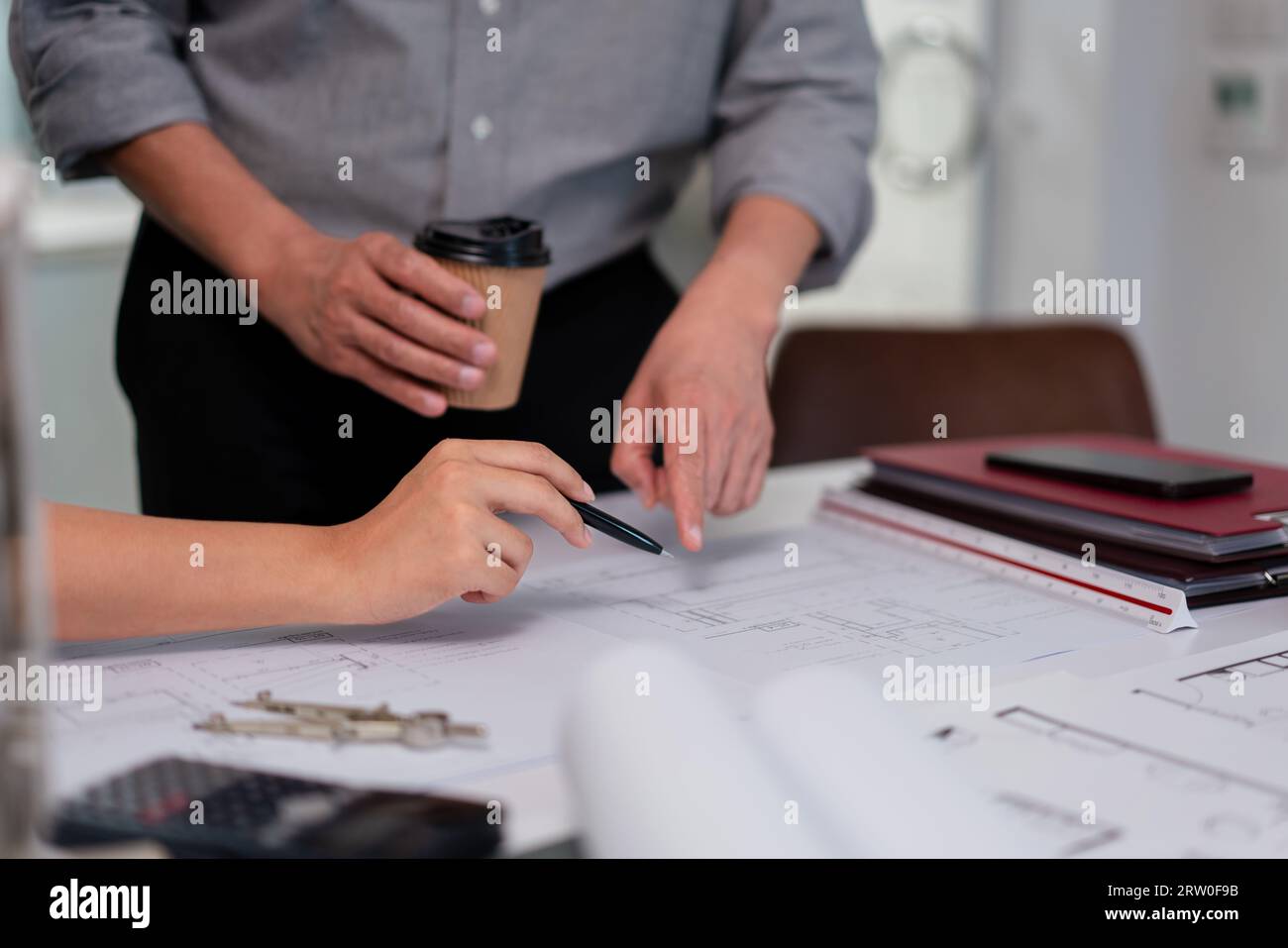 Two architects pointing on blueprint to analysis and planning about ...