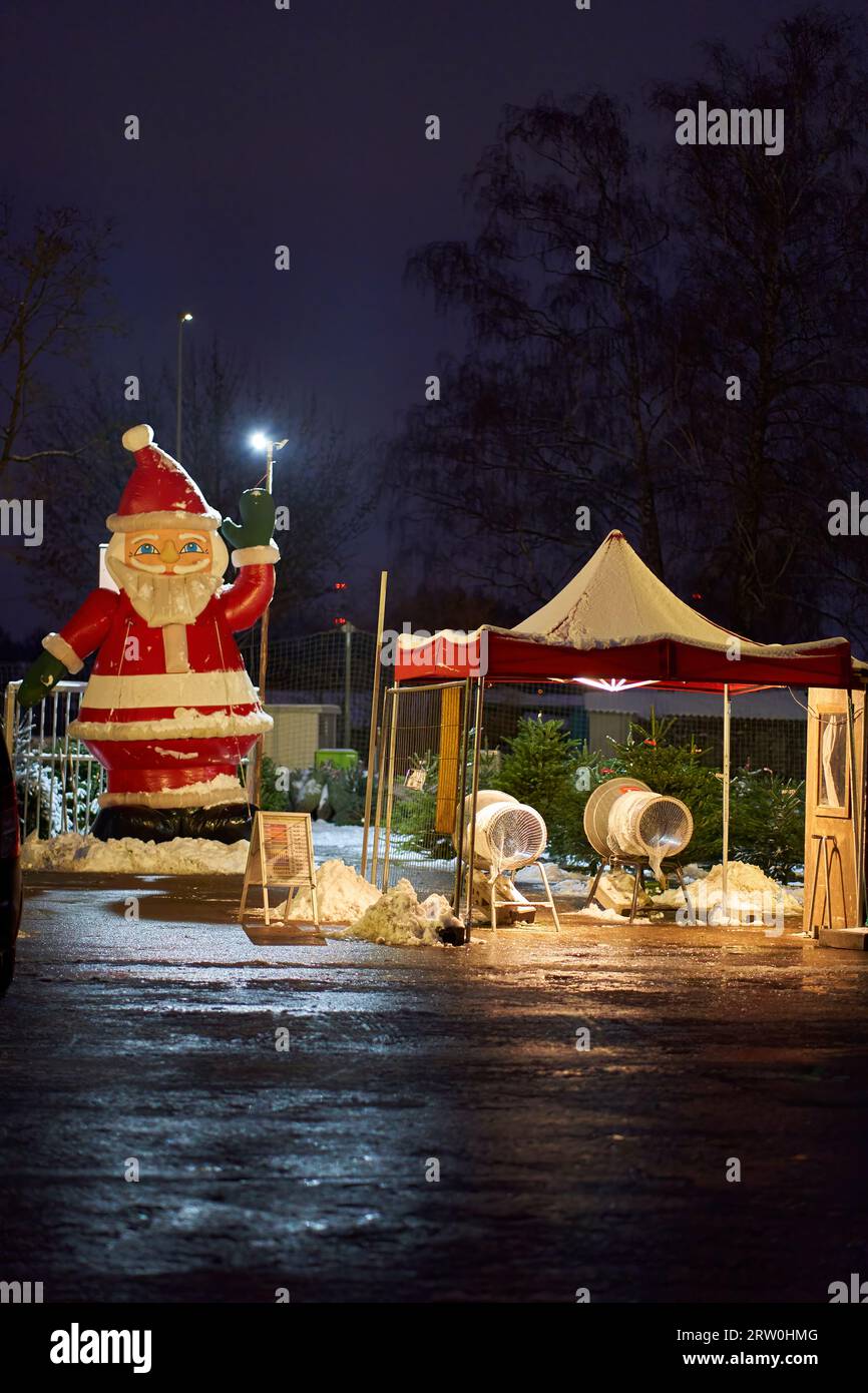 Sale of Christmas trees in December. Market stall in the late evening ...