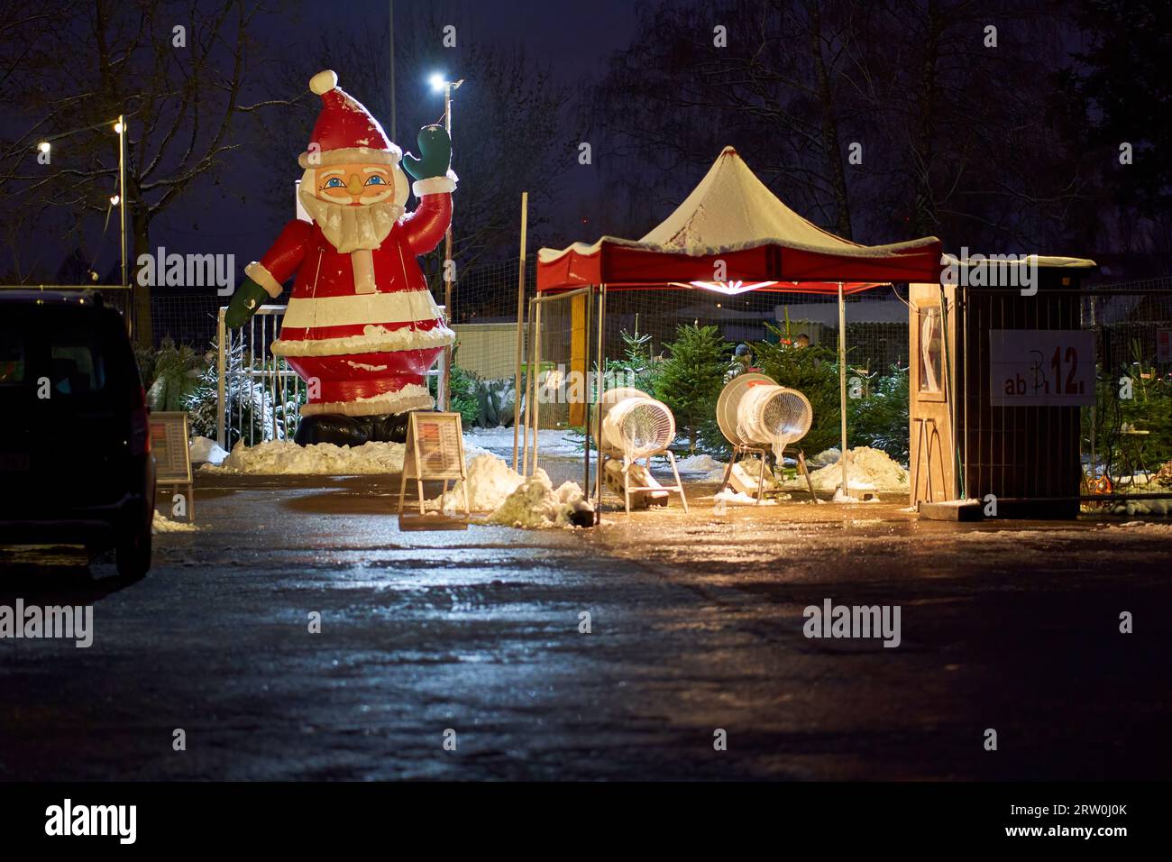 Sale of Christmas trees in December. Market stall in the late evening ...