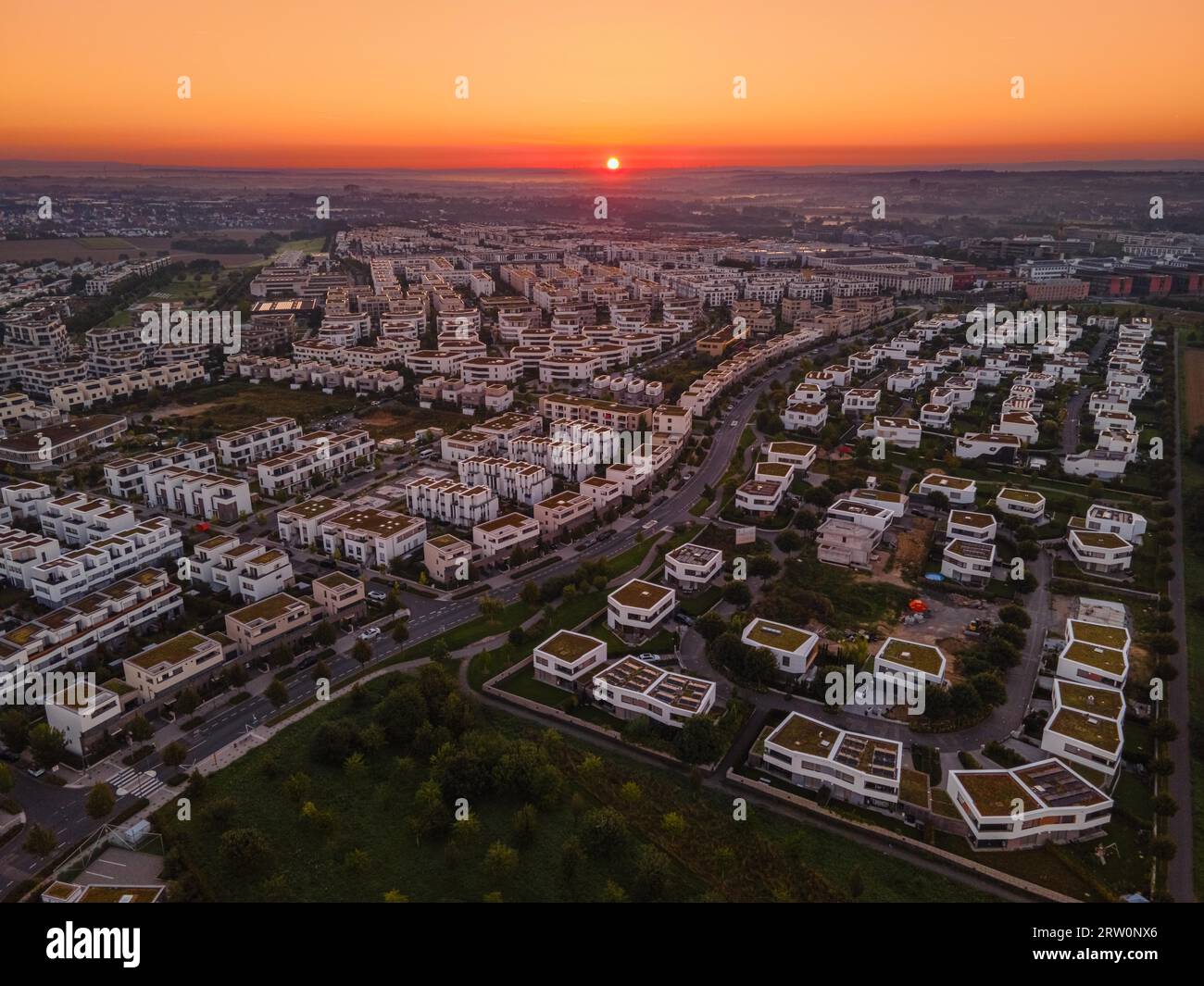 The sun rises behind the Riedberg district of Frankfurt. (Aerial photo ...