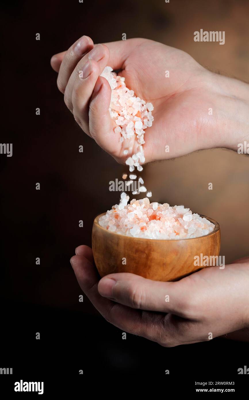 Man pouring himalayan salt crystals from his hand Stock Photo - Alamy