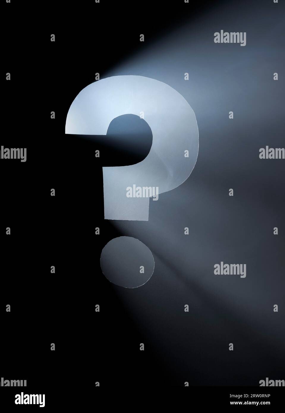 Question Mark. Hole cut in cardboard, smoke machine and spotlight. The ...