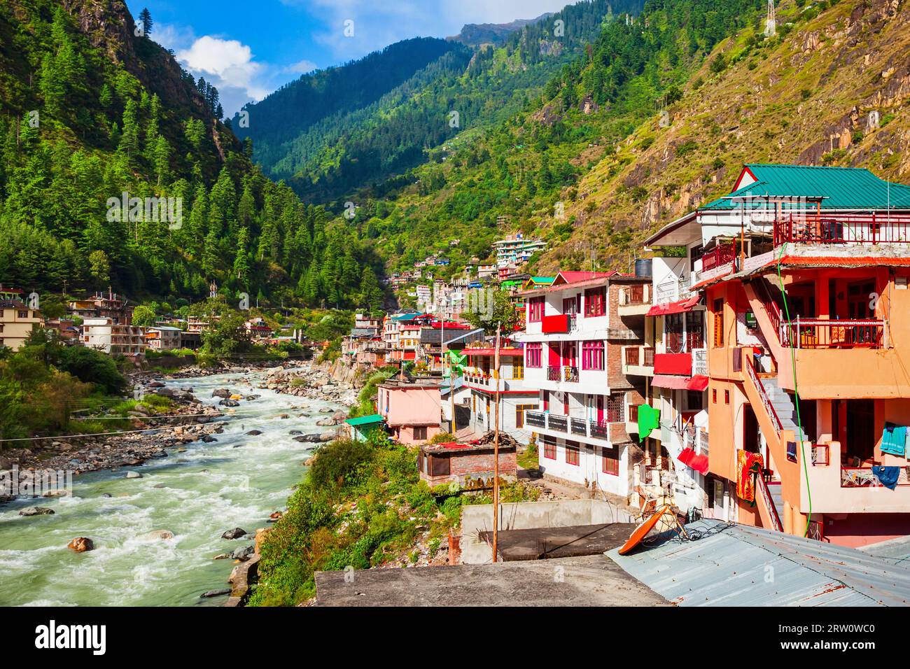 Colorful local houses and Parvati river in Manikaran village in Parvati ...