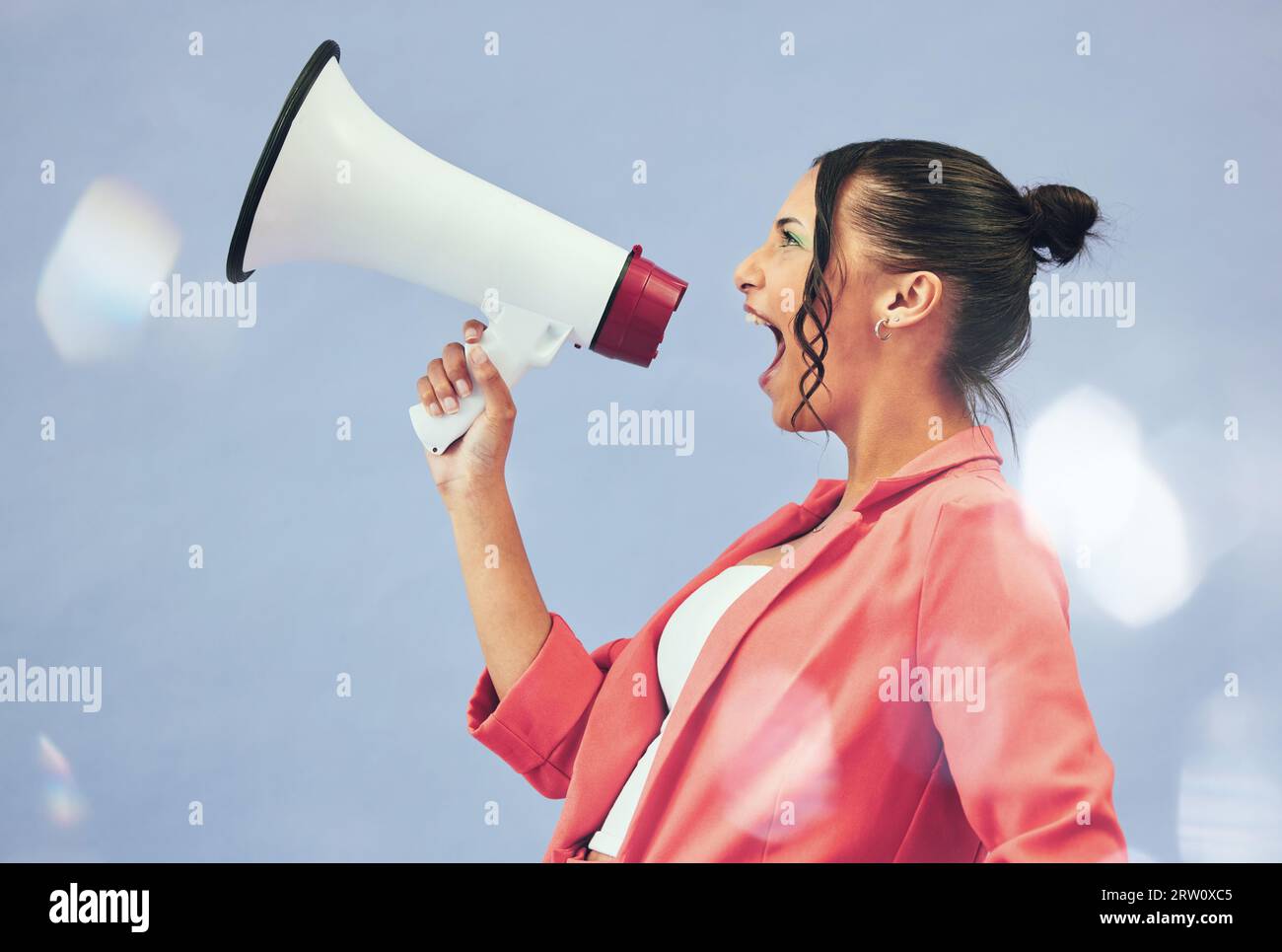 Megaphone, protest or motivation with a woman shouting on a blue ...
