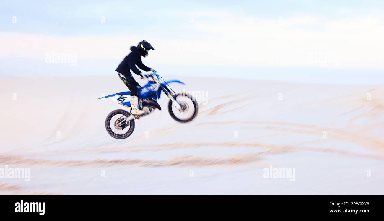 Sand, jump or athlete driving motorcycle for fitness, adventure or ...
