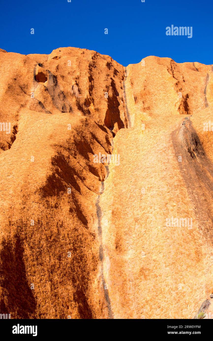 Uluru rock detail showing previous waterfalls on a clear winter#39, s ...