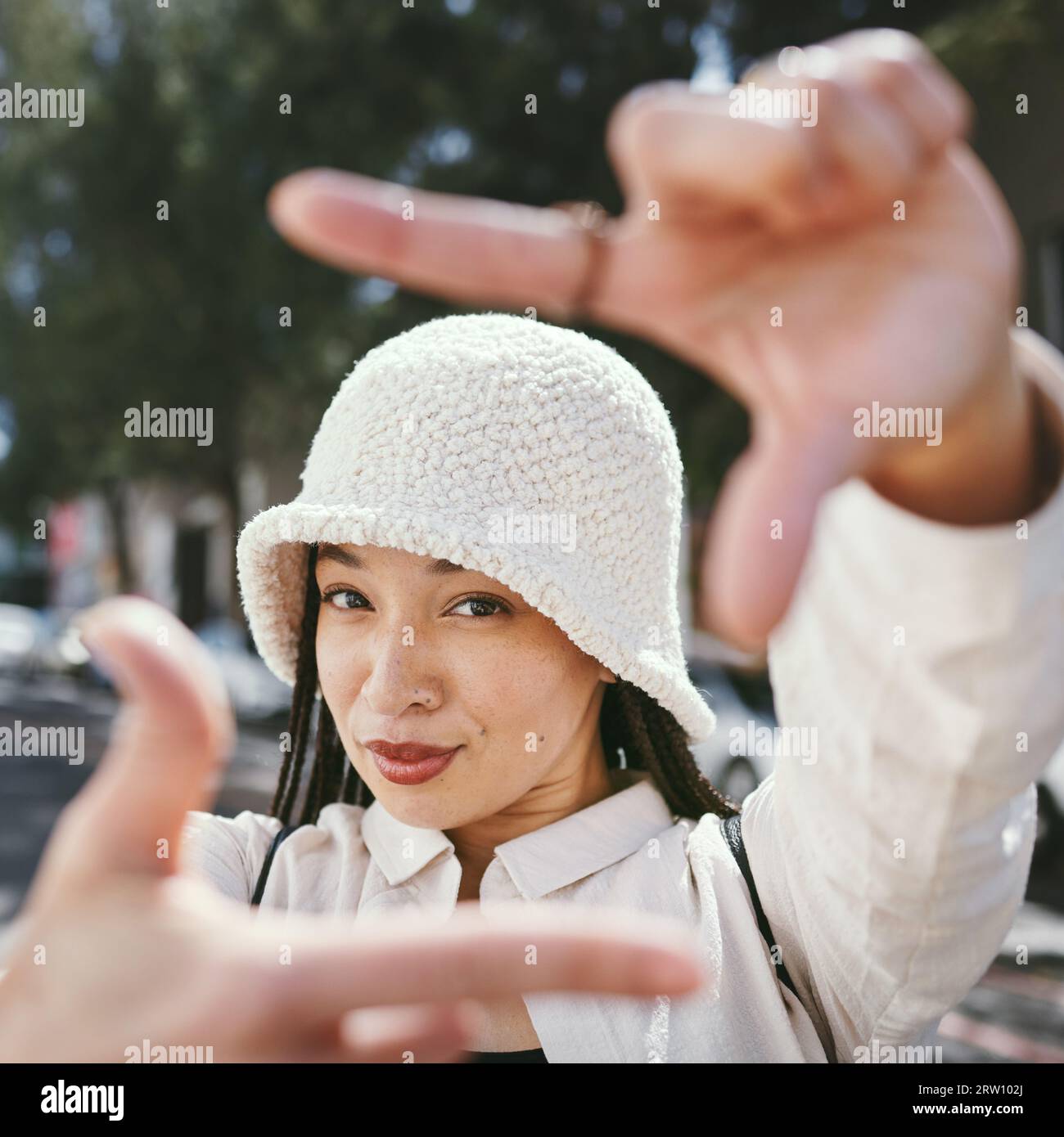 Portrait, hands frame and happy woman in city or urban town outdoor ...