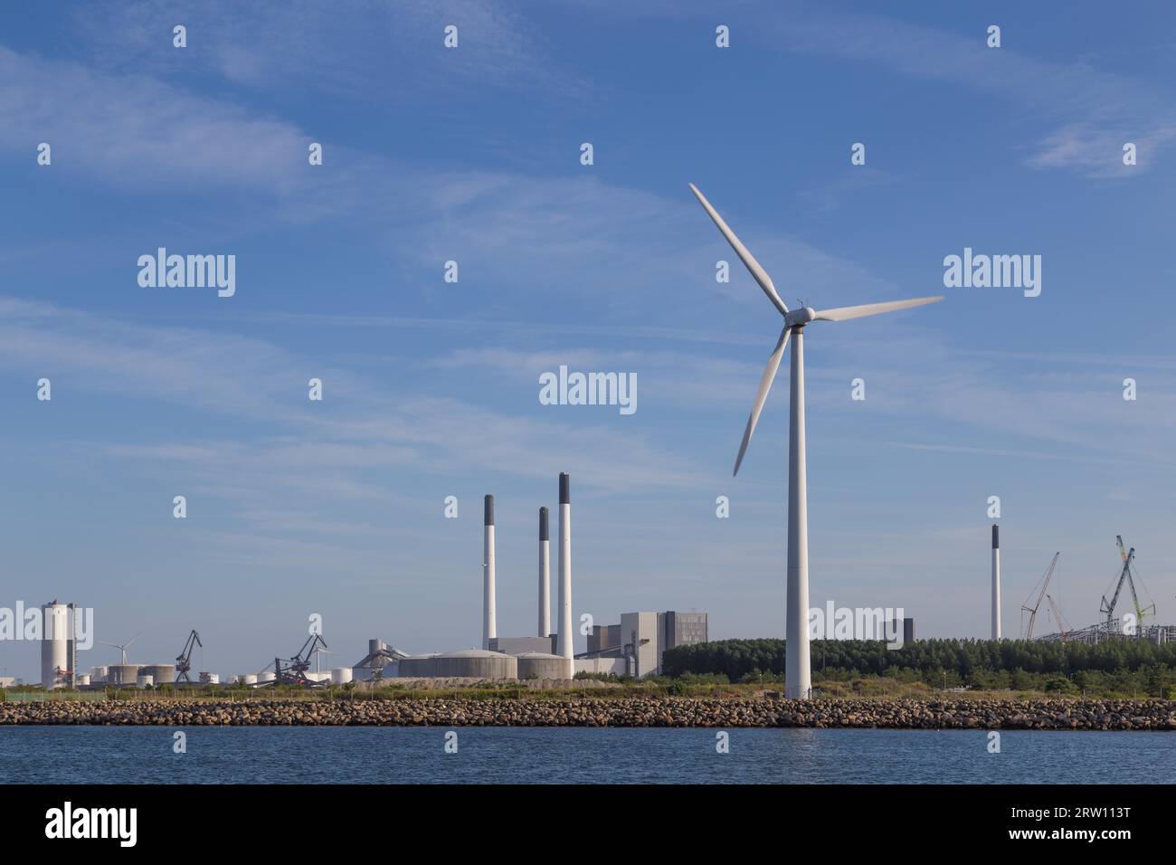 Photograph of wind power plants and industrial buildings in Copenhagen ...