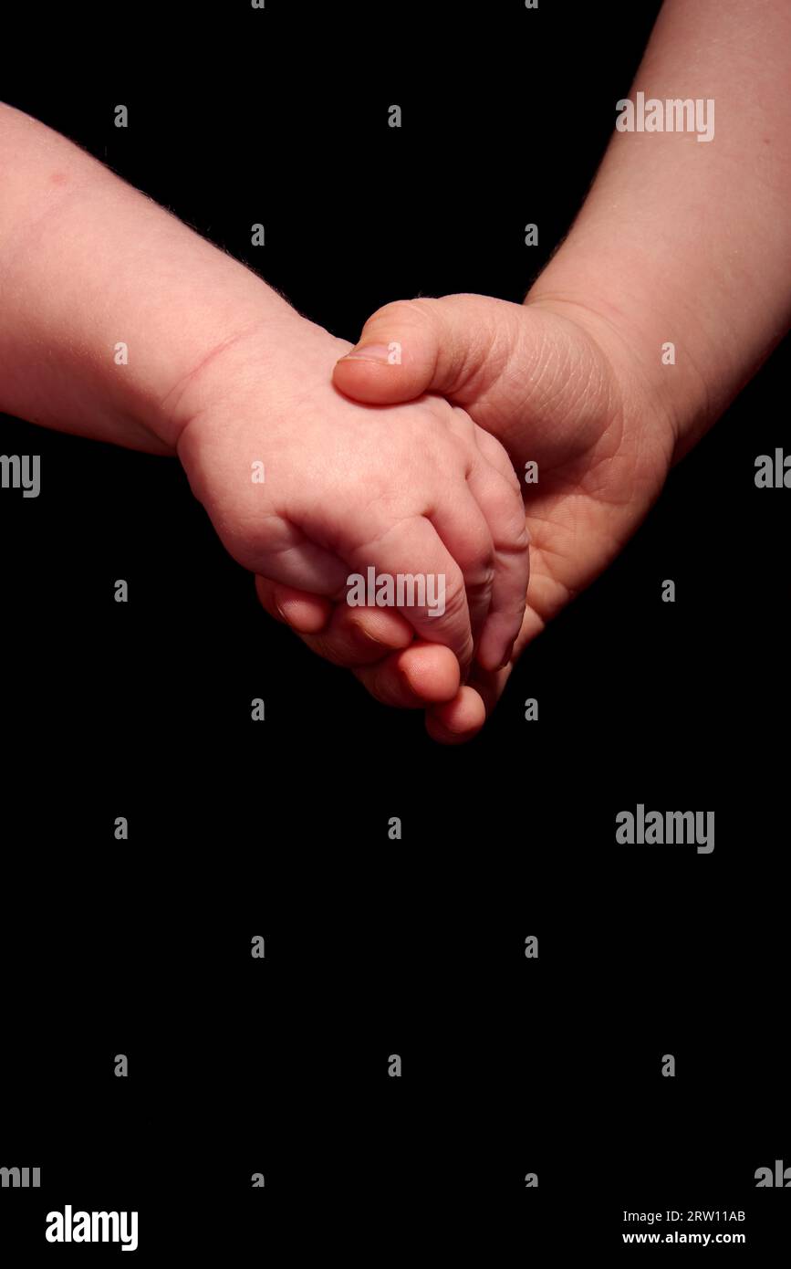 Sister holding brothers hand Stock Photo - Alamy