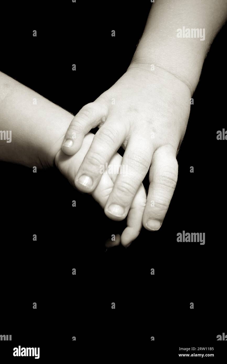 Sister holding brothers hand Stock Photo - Alamy