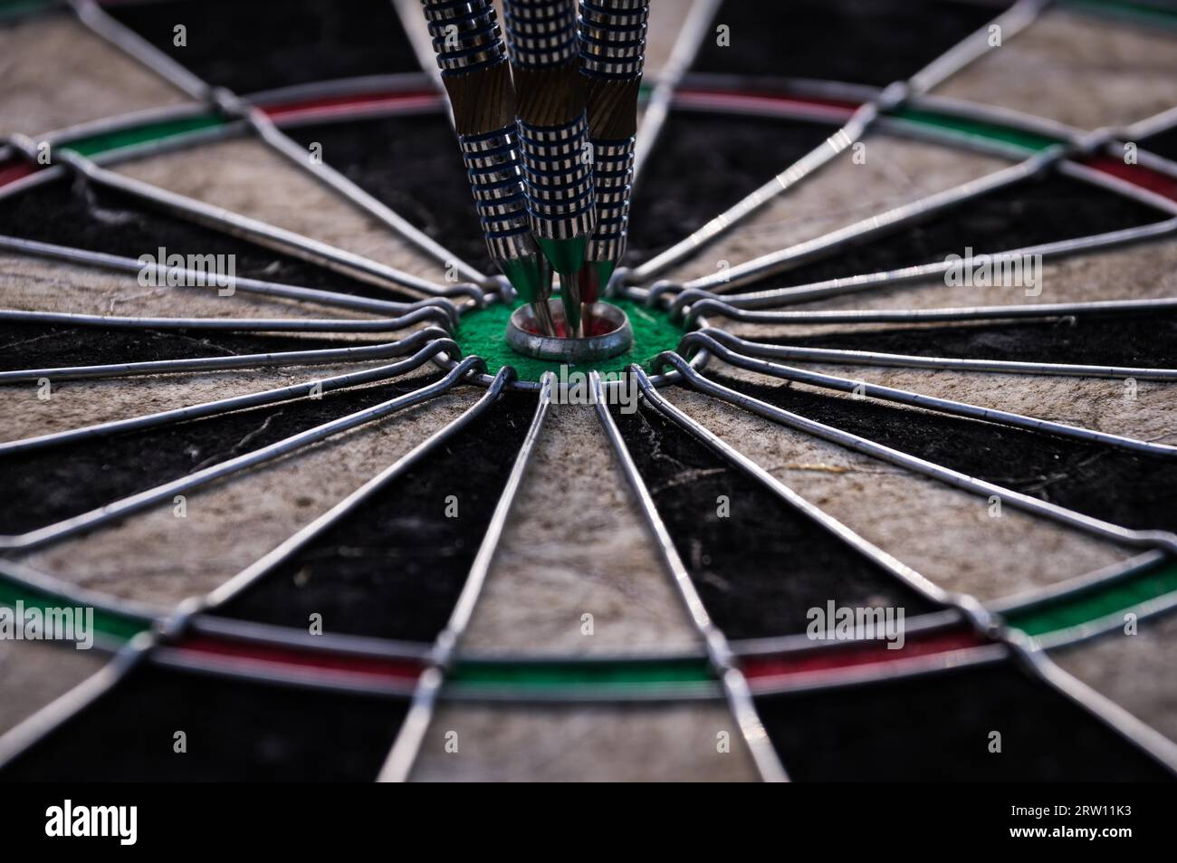 Three dart arrows hitting in the target center of dartboard ... Three dart arrows hitting in the target center of dartboard ...