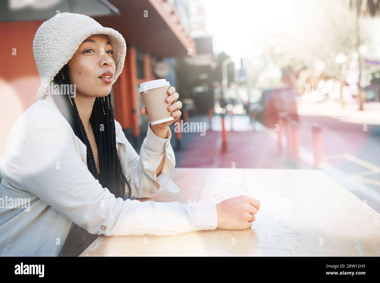 Outdoor, coffee shop and woman relax with drink at cafe, restaurant or ...