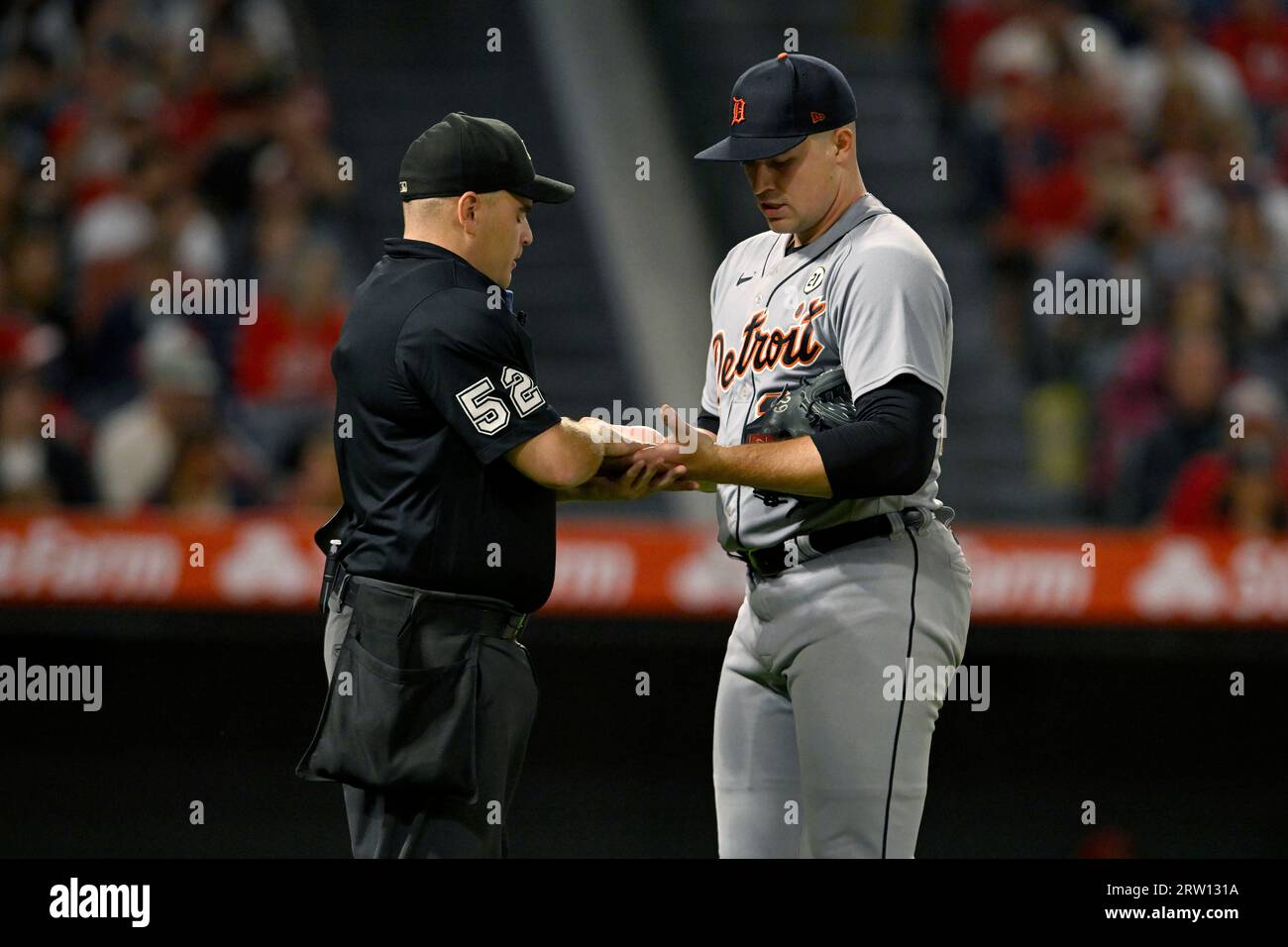 Detroit Tigers starting pitcher Tarik Skubal, right, gets his hands checked by home plate umpire ...