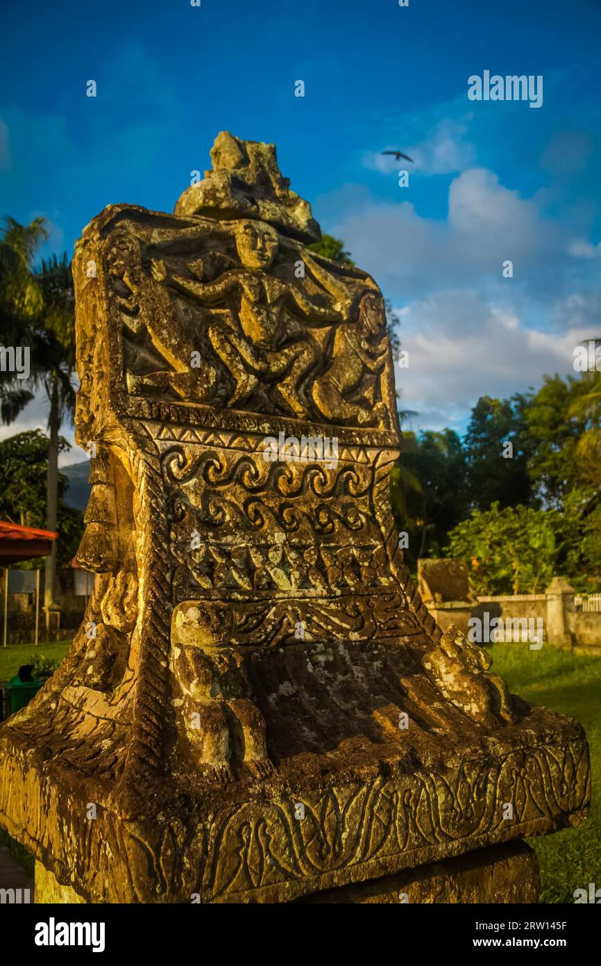 Photo of old stone monument with carvings of patterns and small person ...