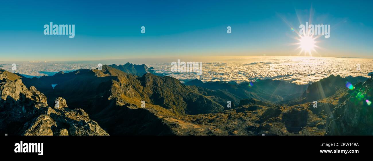 Panoramic photo of mountains and clouds at sunrise on Mount Wilhelm ...
