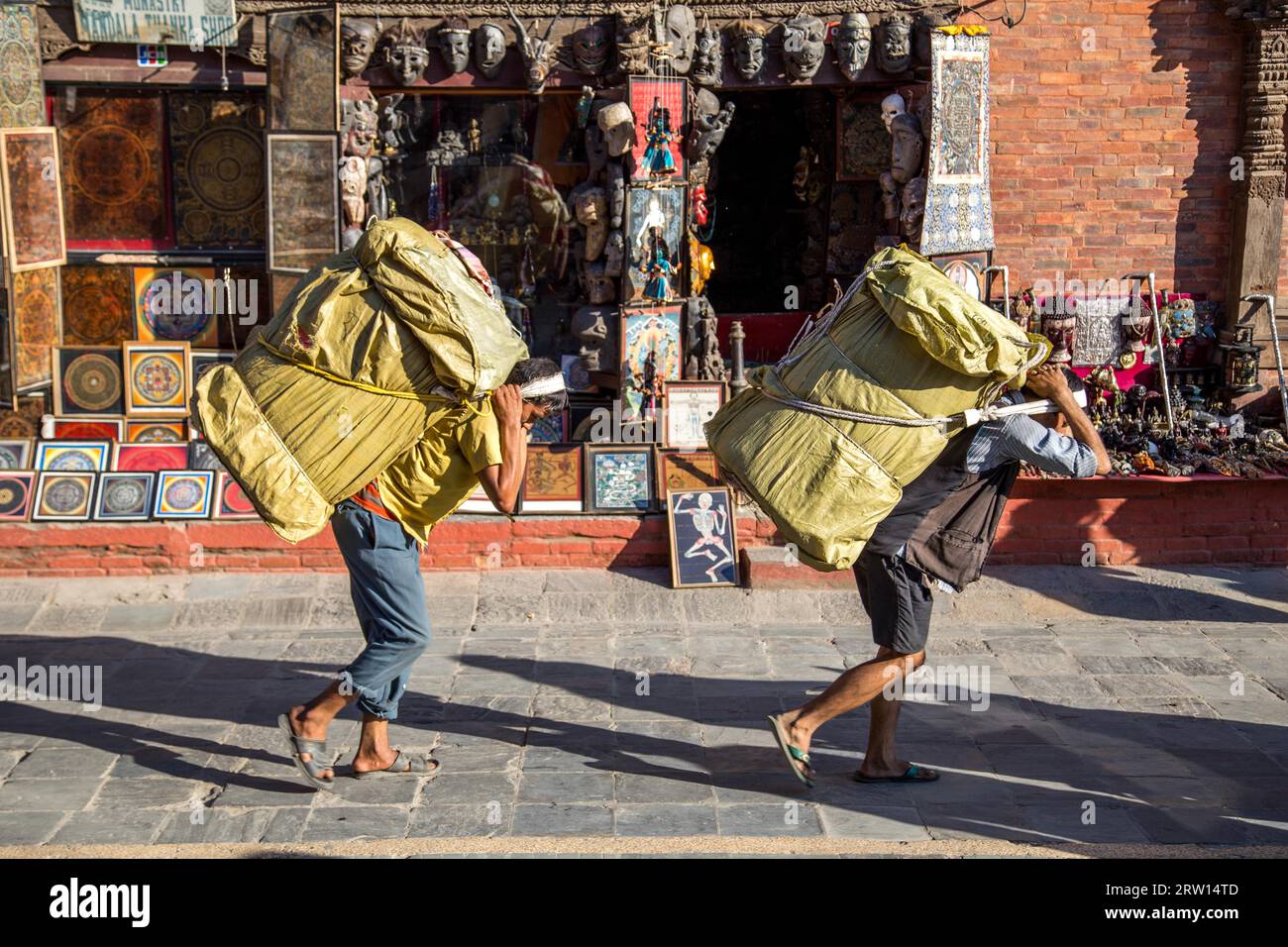 Kathmandu, Nepal, October 19, 2014: Two nepalese men carrying heavy ...