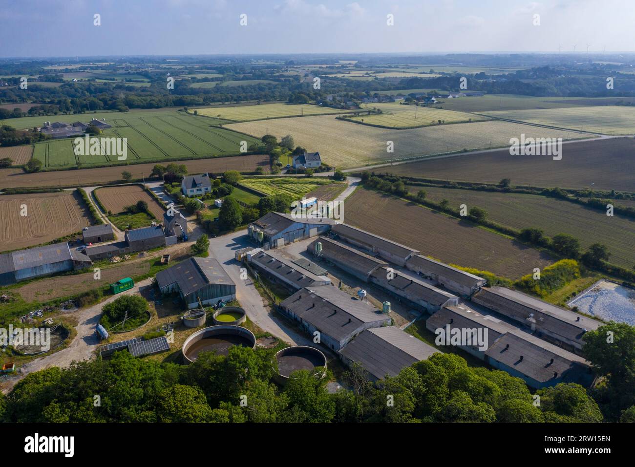Aerial view of pig farm with closed stables and manure reservoirs ...