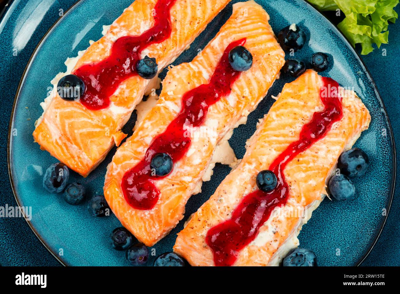 Baked salmon fish with blueberry berry sauce. Salmon fillets, grilled ...