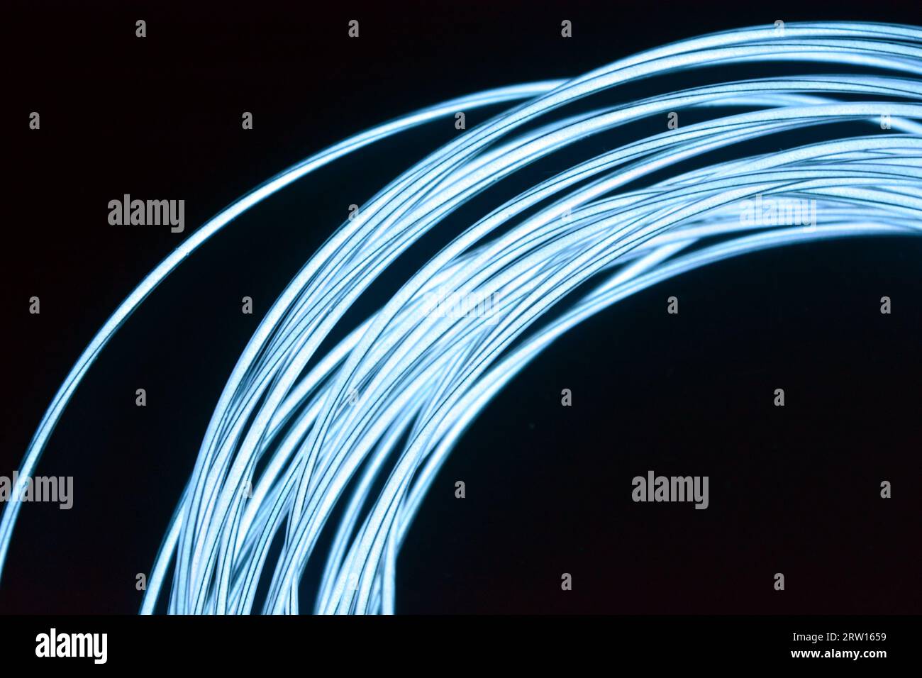 An unusual, unique glowing background of chaotically stacked thin wires ...