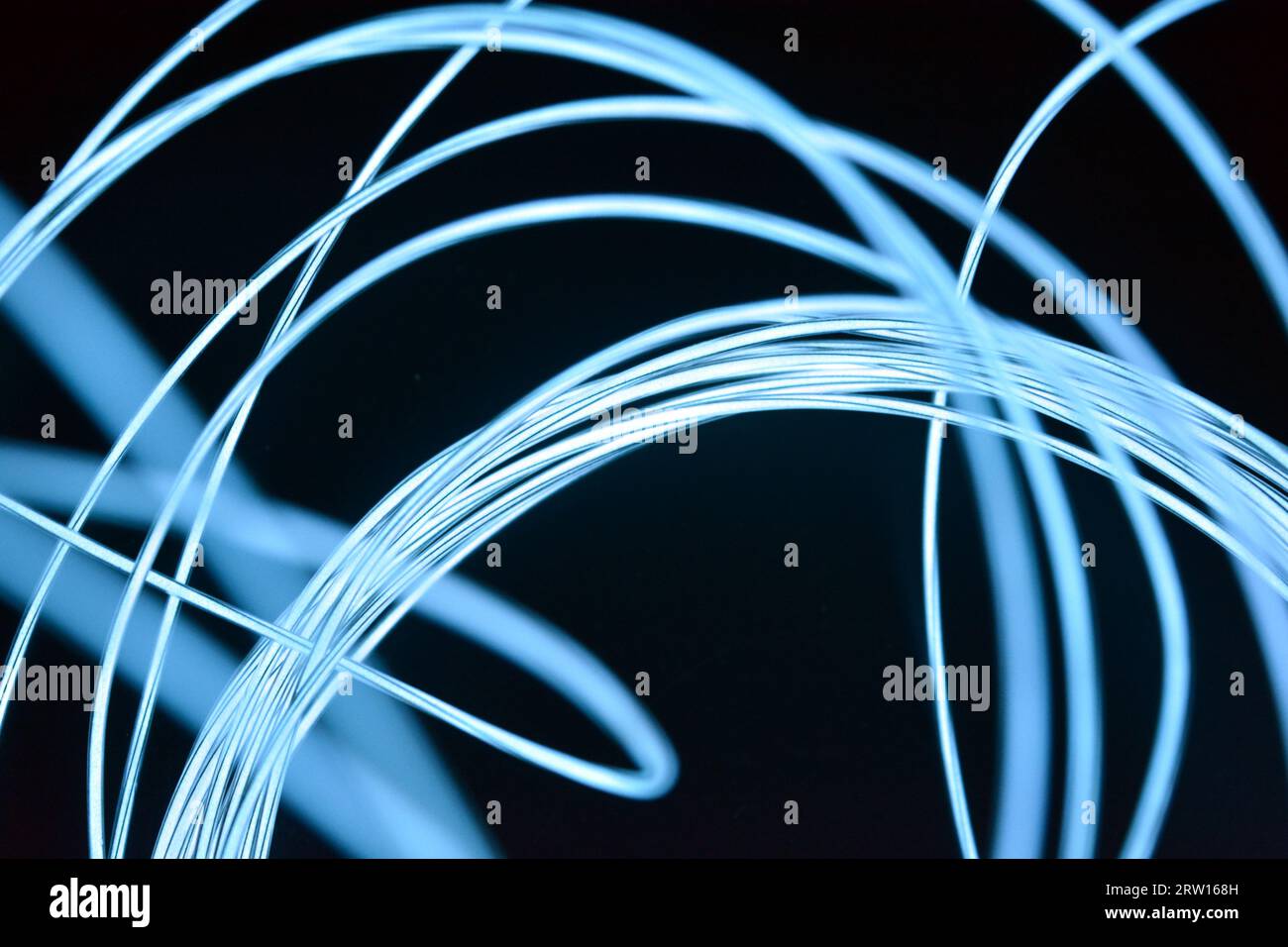 An unusual, unique glowing background of chaotically stacked thin wires ...