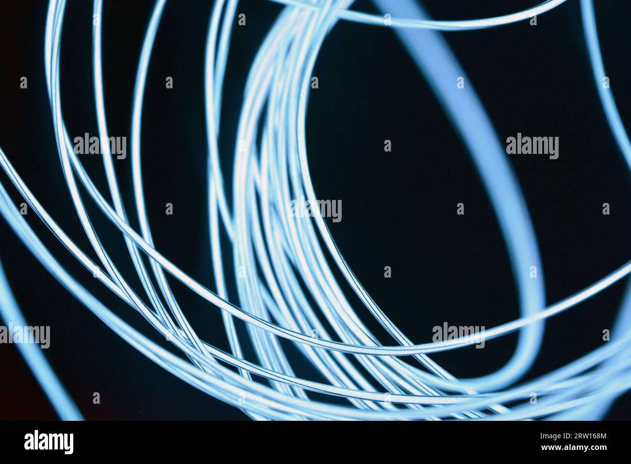 An unusual, unique glowing background of chaotically stacked thin wires ...