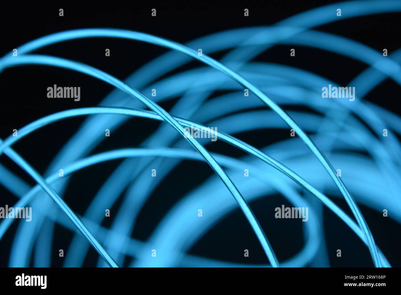 An unusual, unique glowing background of chaotically stacked thin wires ...