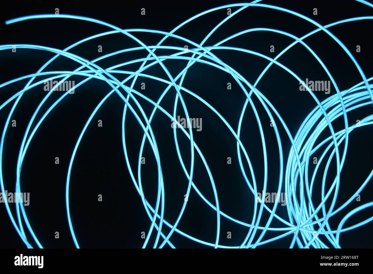 An unusual, unique glowing background of chaotically stacked thin wires ...
