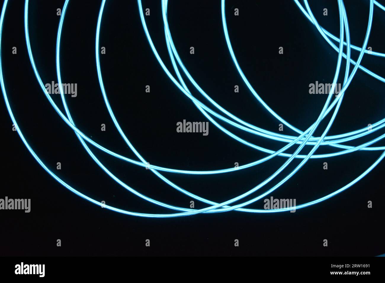 An unusual, unique glowing background of chaotically stacked thin wires ...