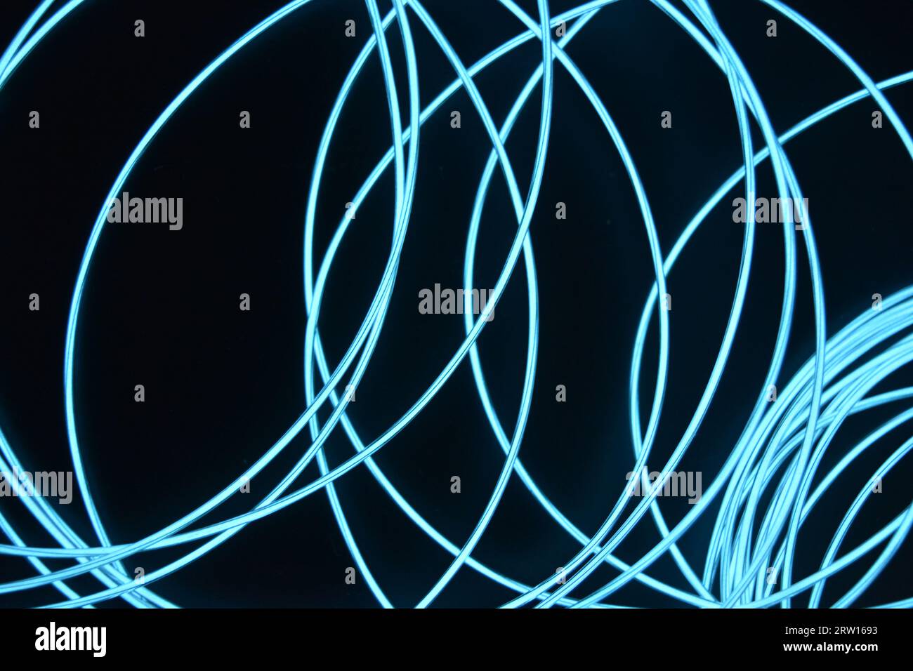 An unusual, unique glowing background of chaotically stacked thin wires ...