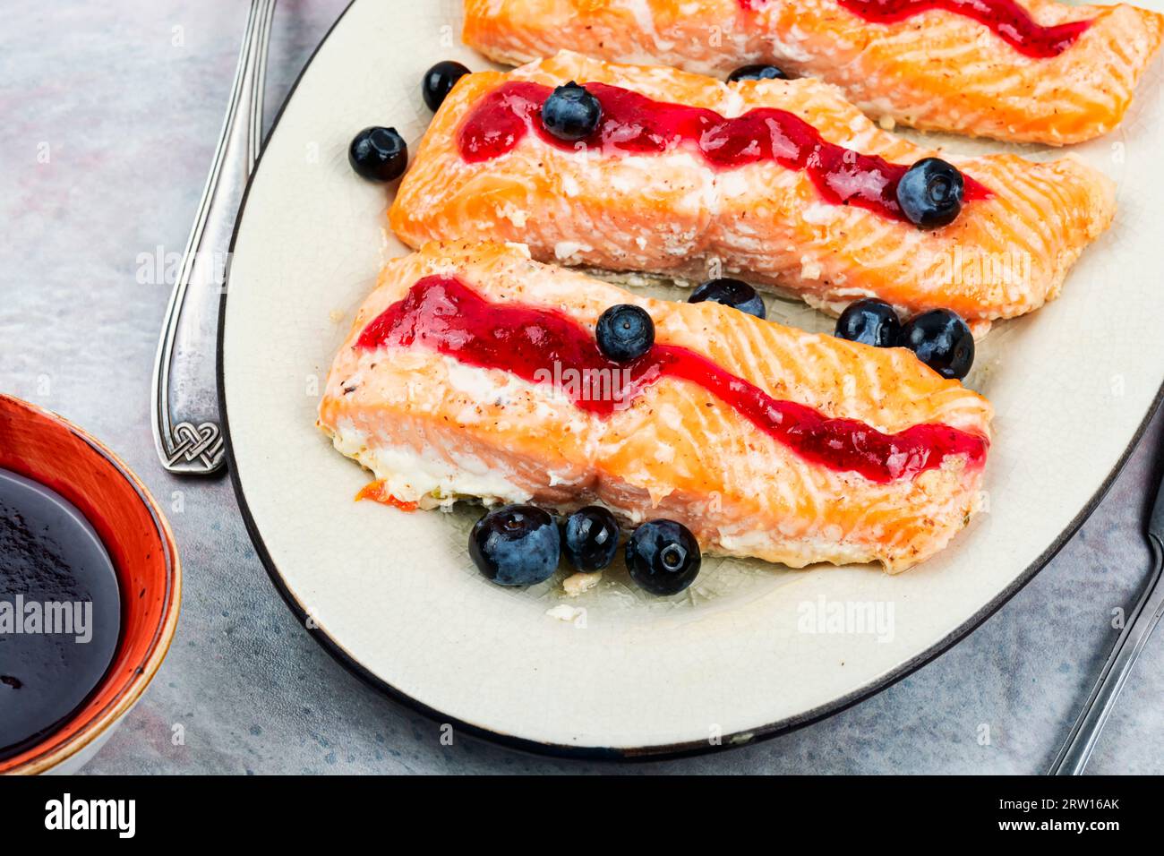 Baked salmon fish with blueberry berry sauce. Salmon fillets, grilled ...