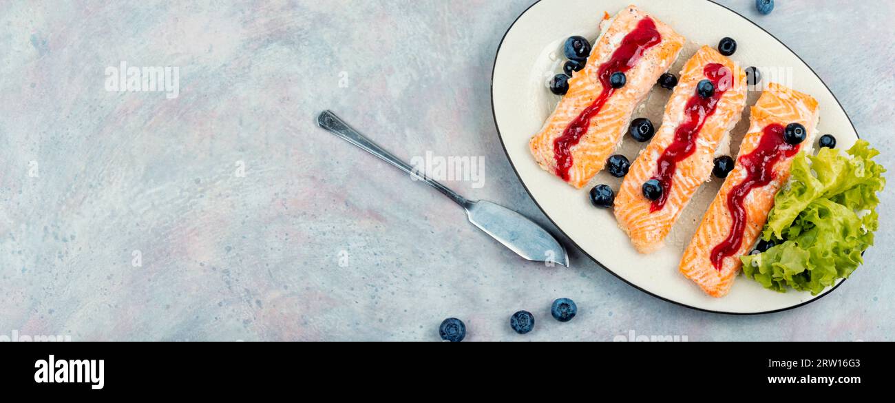 Baked salmon fish with blueberry berry sauce. Salmon fillets, grilled ...