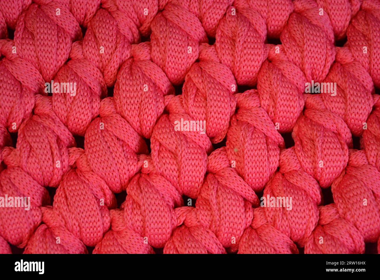 Braided background made of crimson, pink, dense thread. Beautiful ...