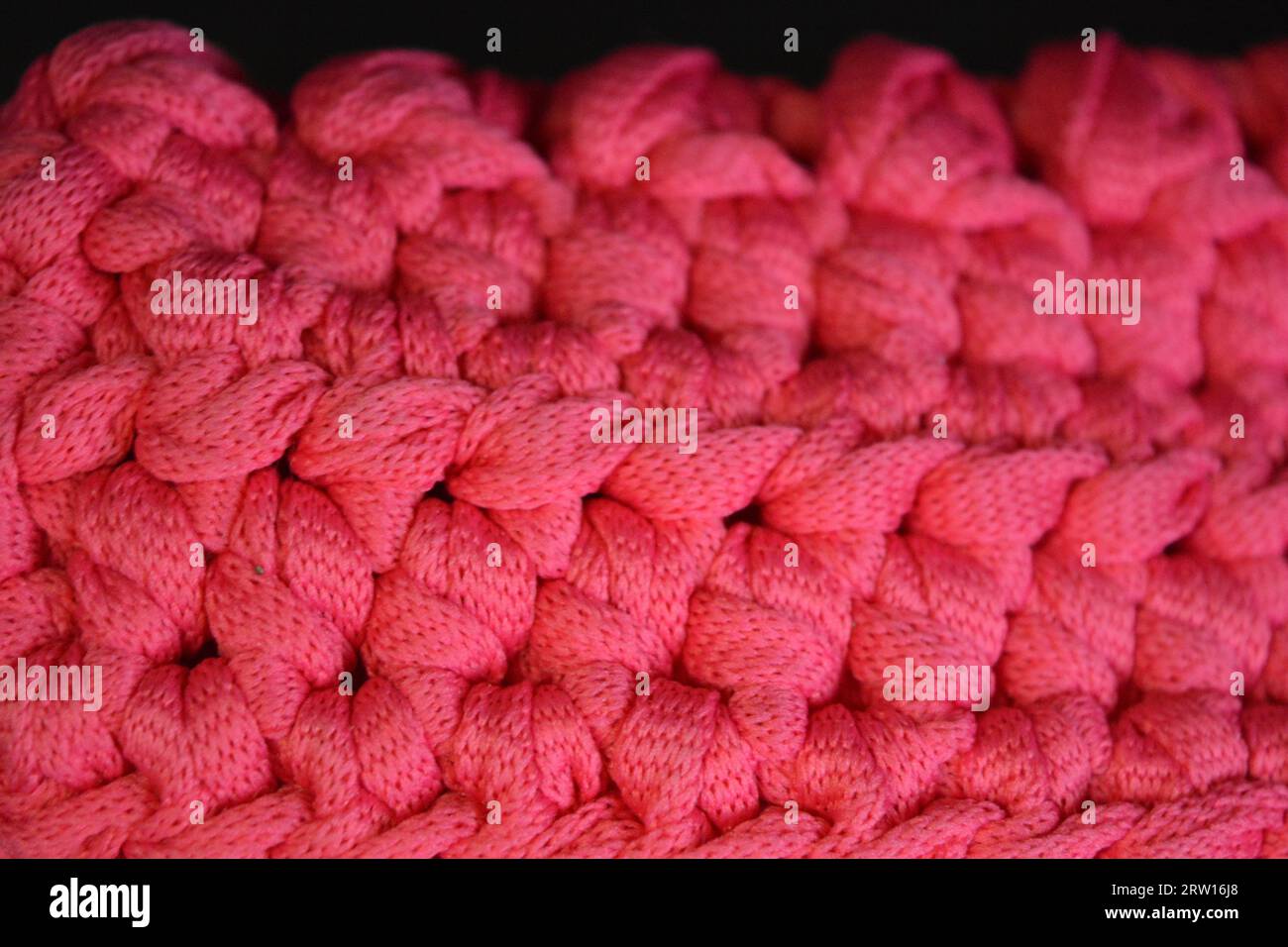 Braided background made of crimson, pink, dense thread. Beautiful ...