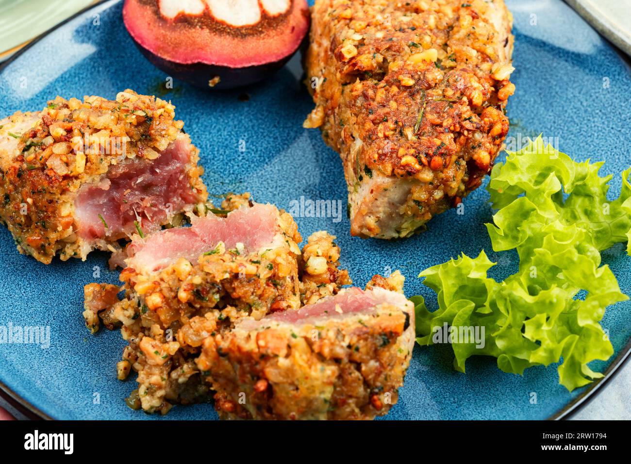 Steak of baked tuna in a nut with a mangosteens. Roasted tuna. Close up ...