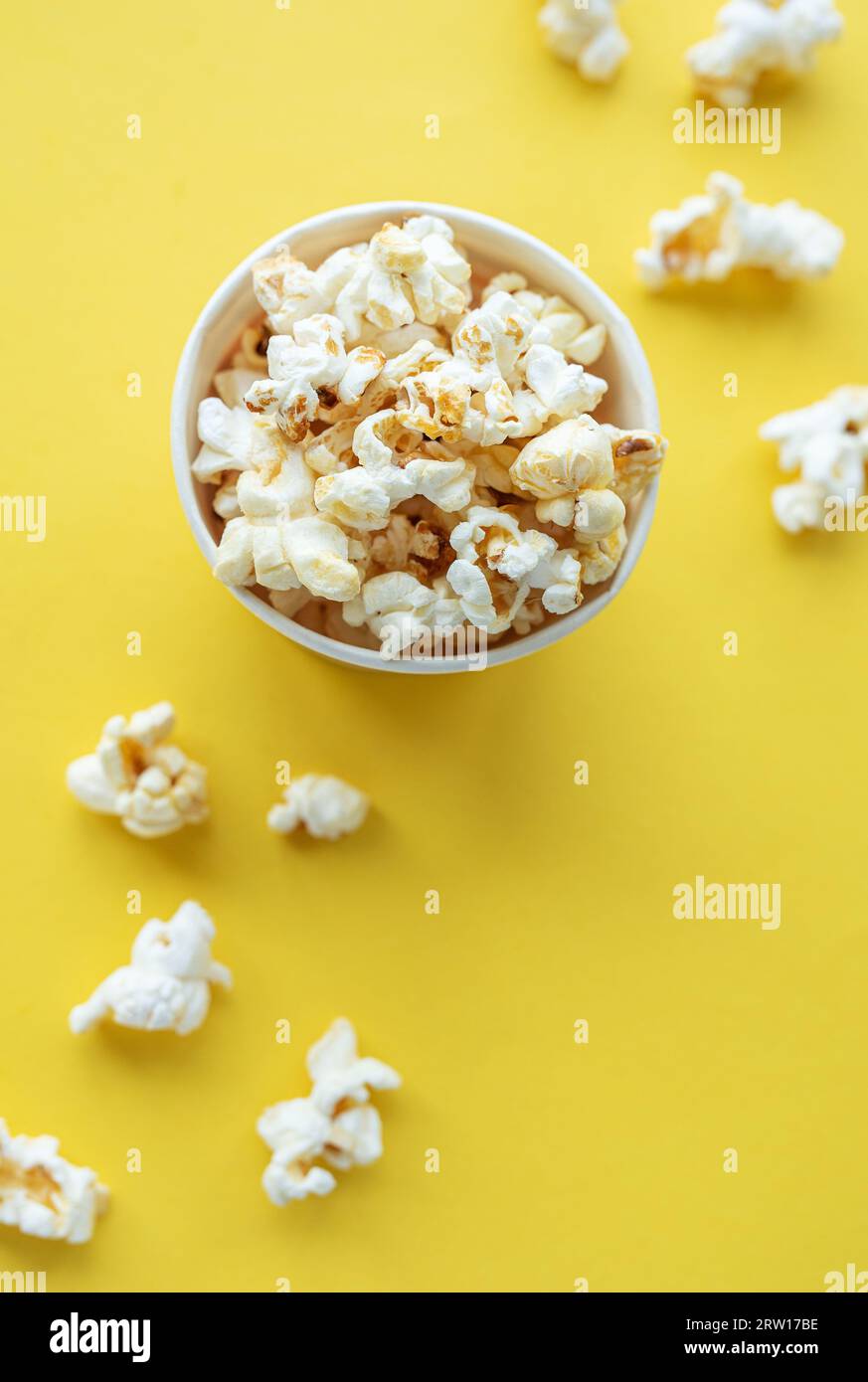Popcorn paper bucket on yellow background Stock Photo - Alamy