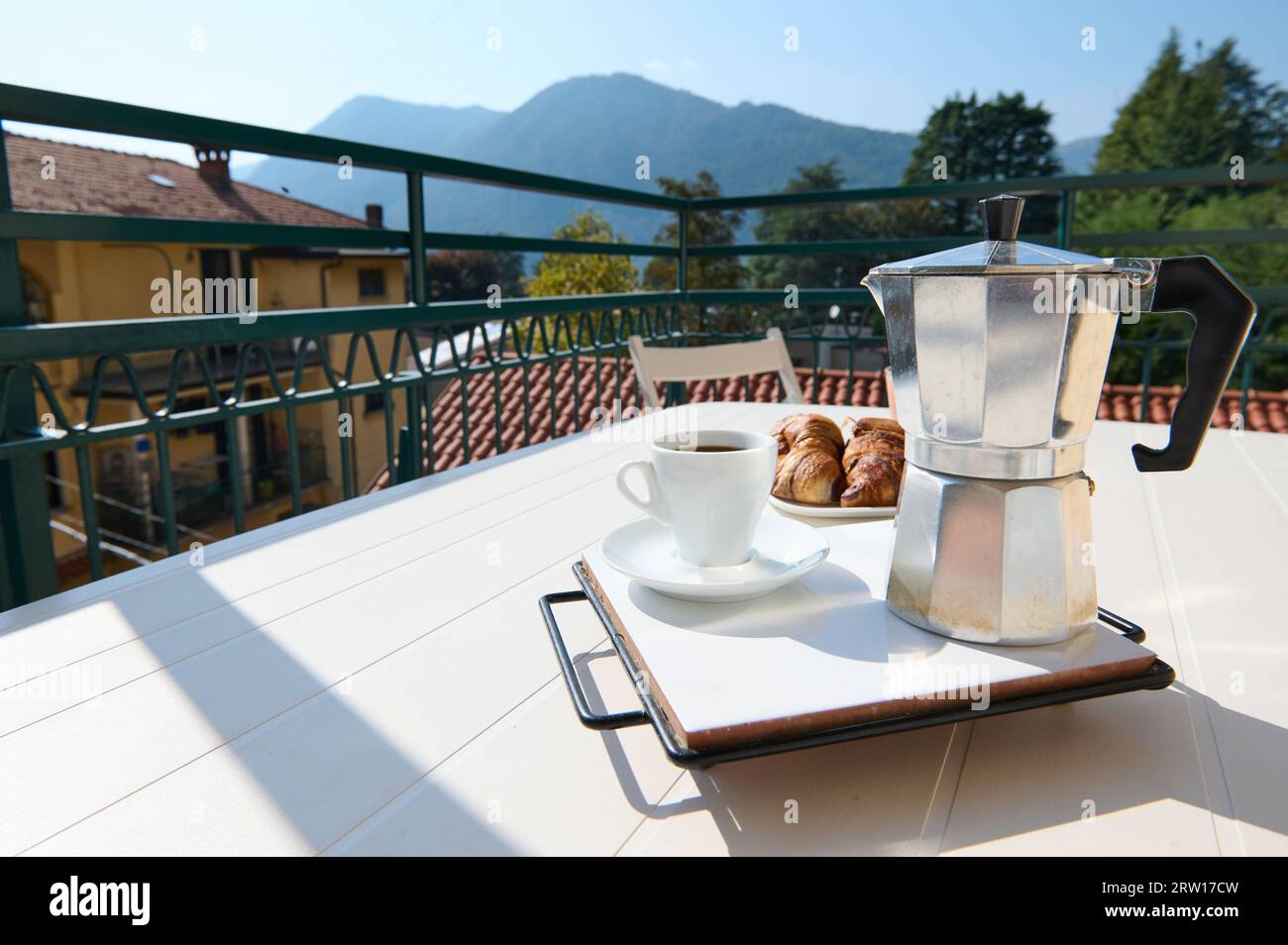 Italian percolator or moka brewer and a cup of freshly brewed coffee on ...