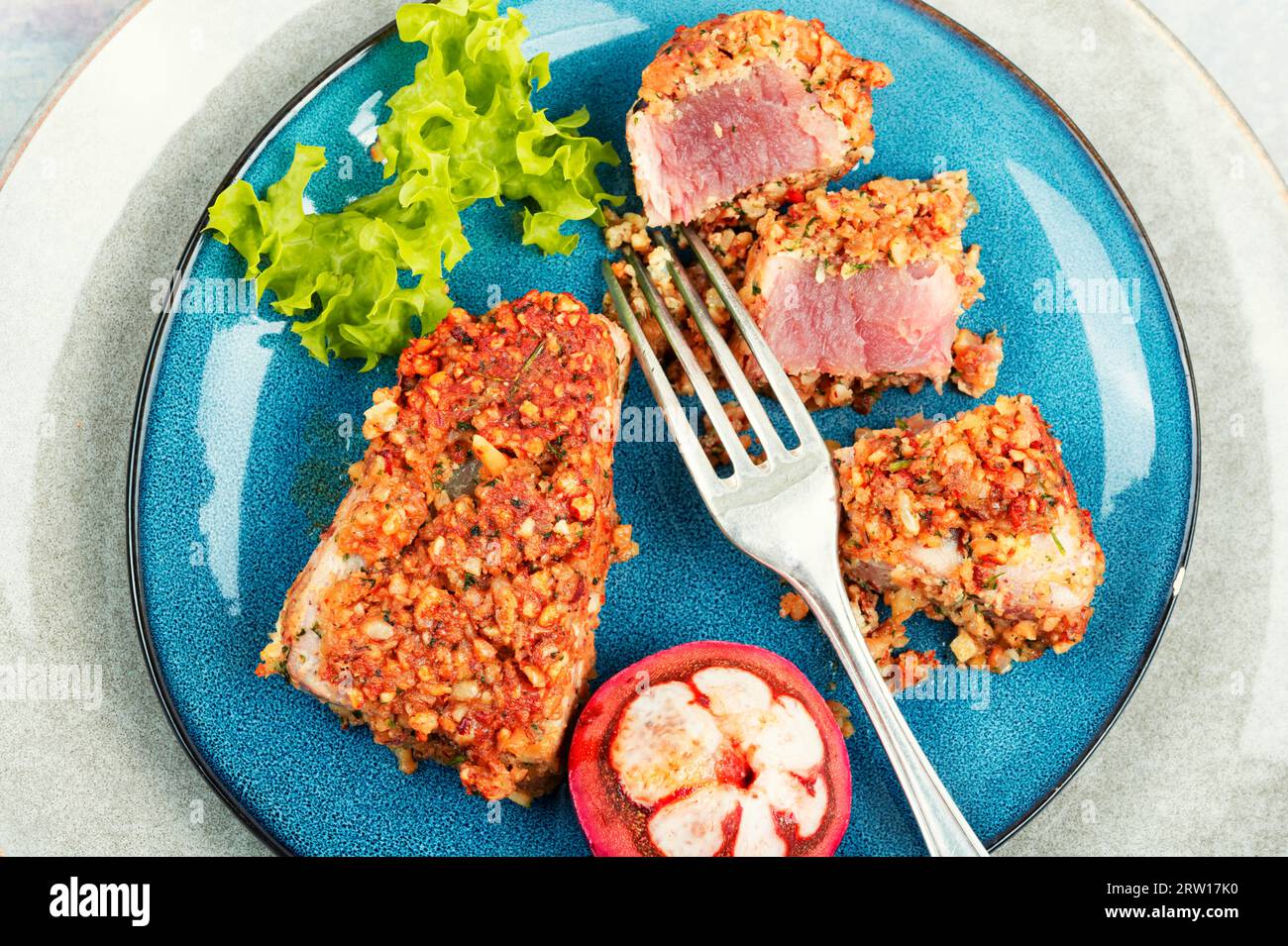 Cooked steak of roasted tuna in a nut panic with a mangosteens Stock ...