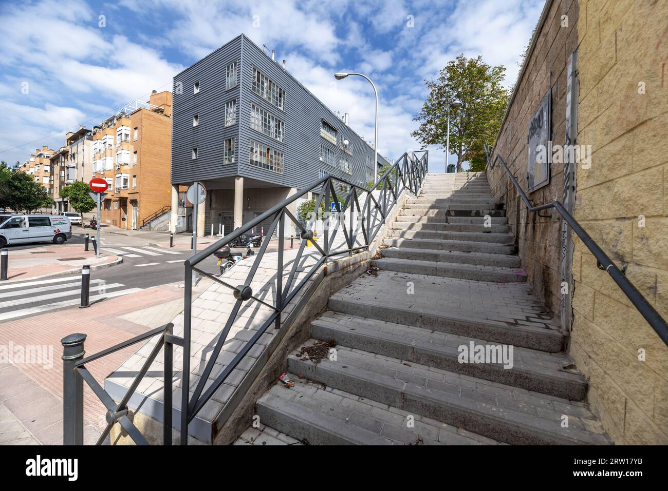 Access stairs to the elevated urban park near a street intersection ...