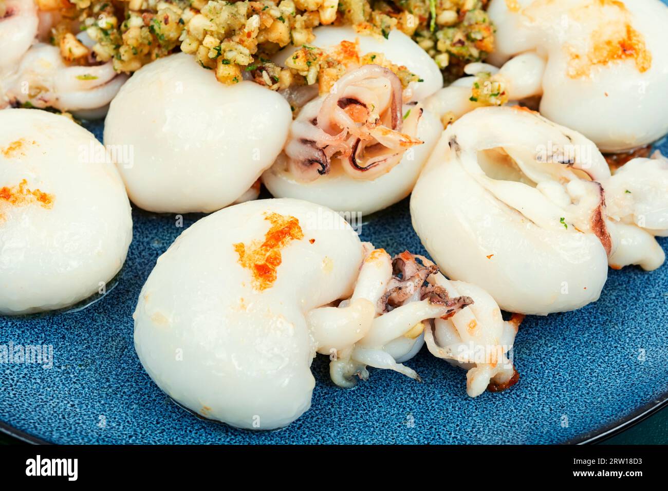 Baked young squids served with nut garnish. Korea traditional food ...