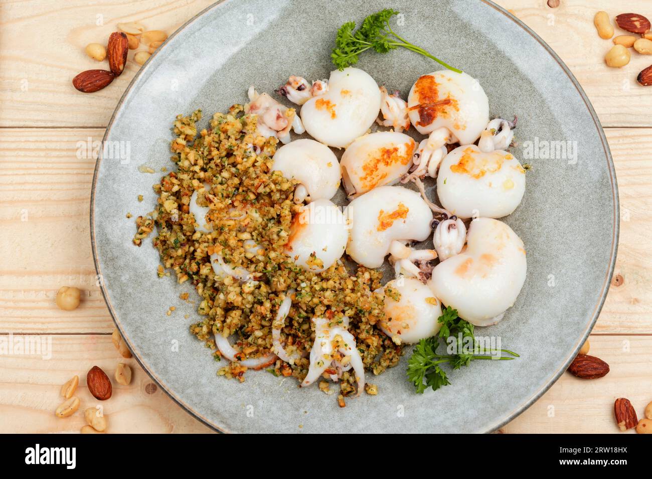 Grilled whole squid or calamari with nut garnish. Roasted whole ...