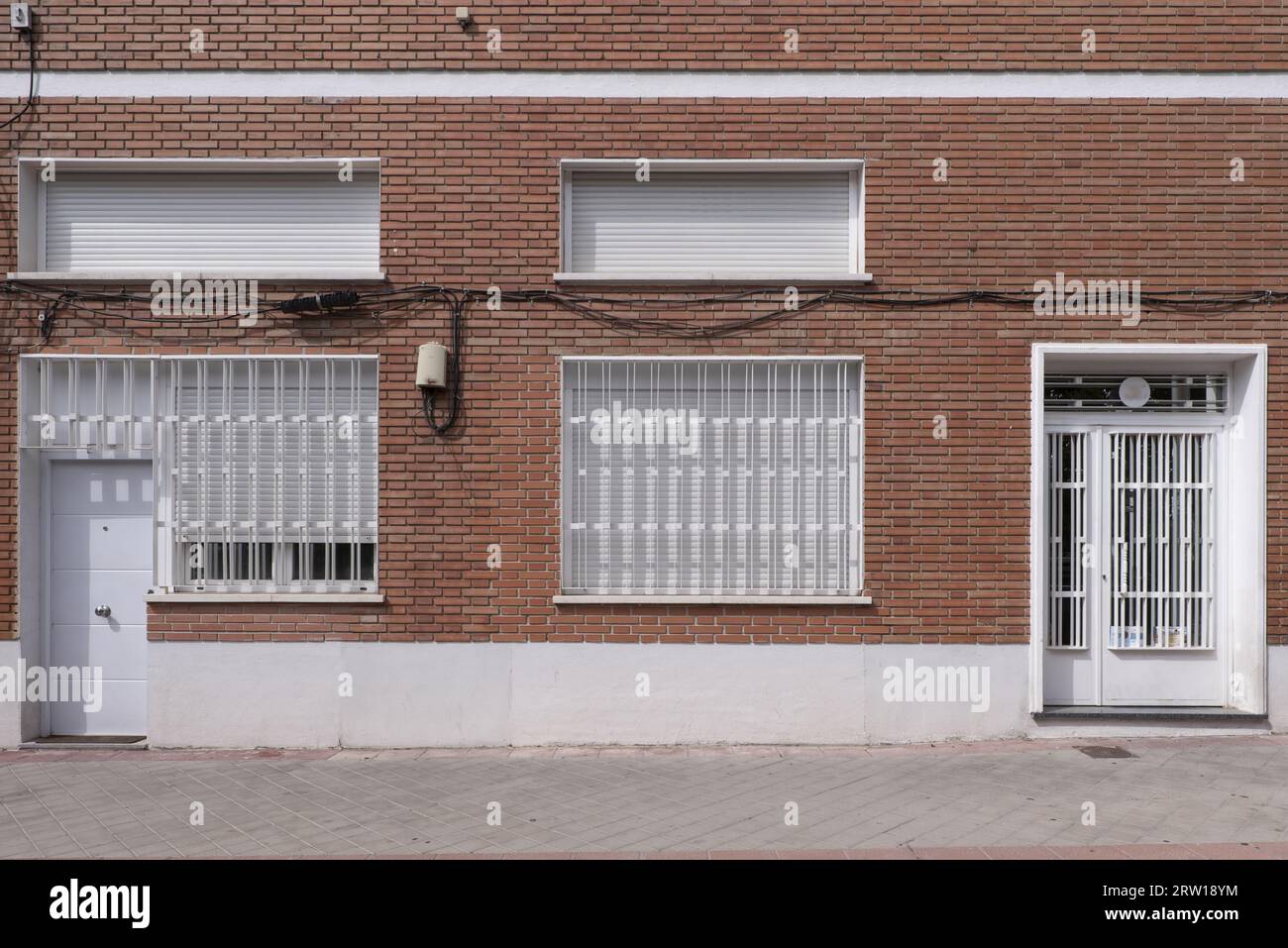 Facade of a residential building with a white metal portal and an ...