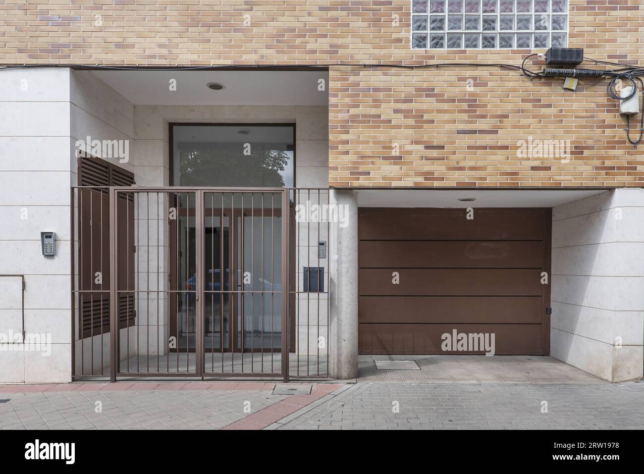 Portal with brown metal fence for access to the homes of a residential ...