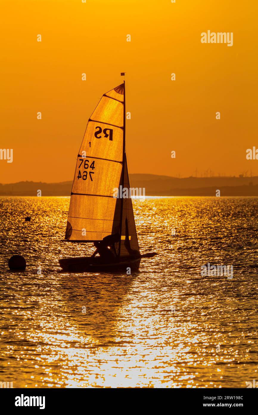 Silhouette of sailing dinghy at sunset hi-res stock photography and ...