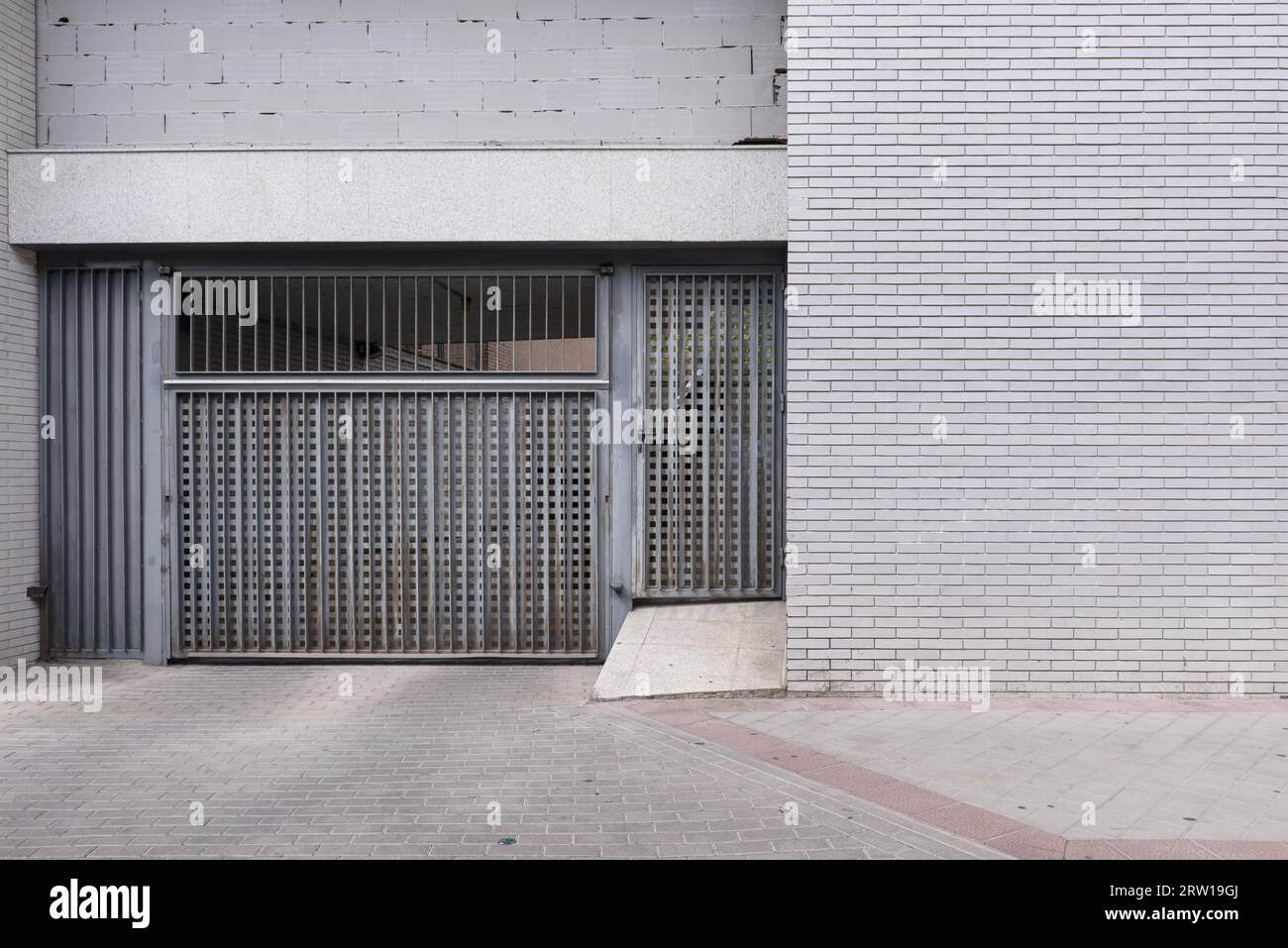 Gray metal portal for access to a home next to the portal of a vehicle ...