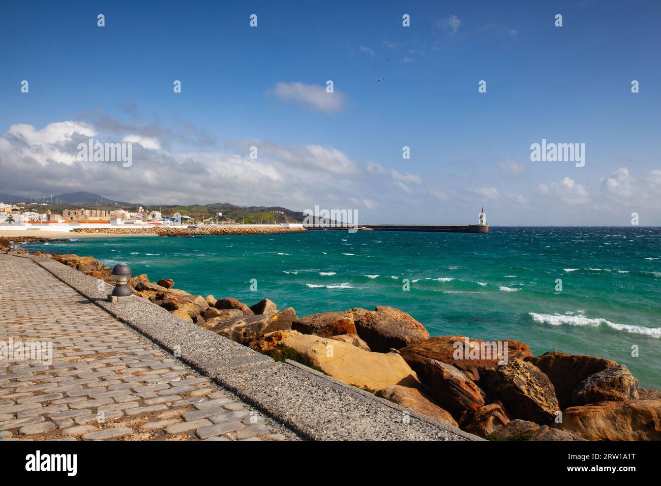 Old harbor and lighthouse in Tarifa, Andalusia, Spain.Tarifa is one of ...