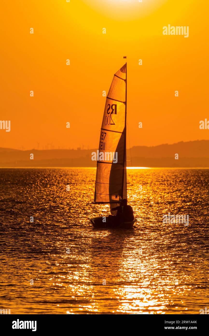 Silhouette of sailing dinghy at sunset hi-res stock photography and ...