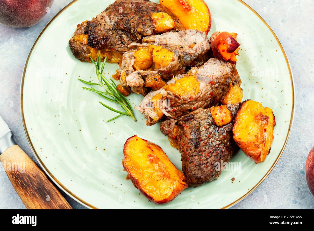 Tasty beef steak with peach in fruit marinade,BBQ Stock Photo - Alamy