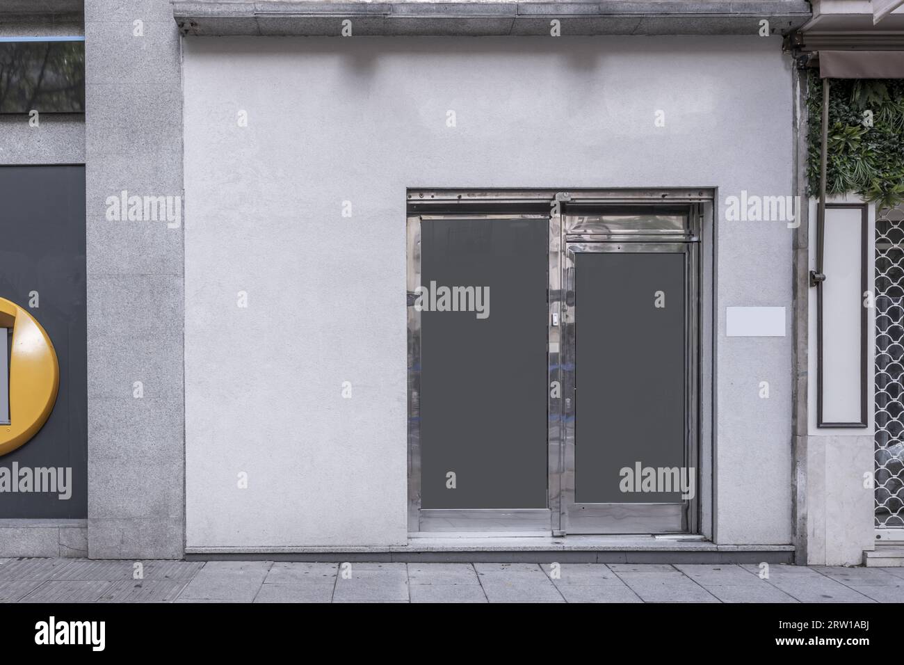 Facade of a commercial premises with a polished steel door at street ...