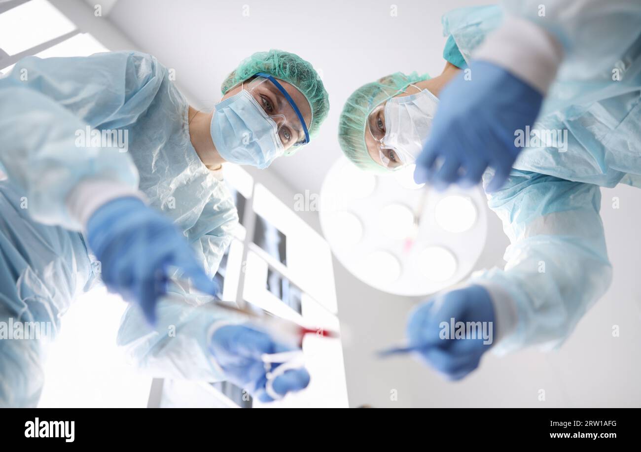 Group of doctors performing surgical operation in clinic Stock Photo ...