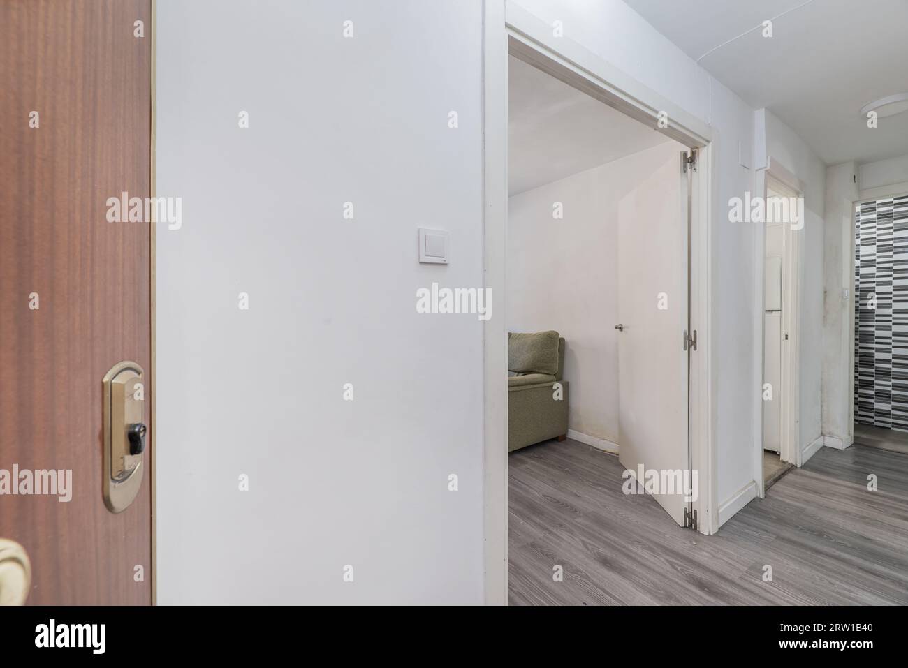 Entrance hall to a home with doors to other compared rooms painted in a ...